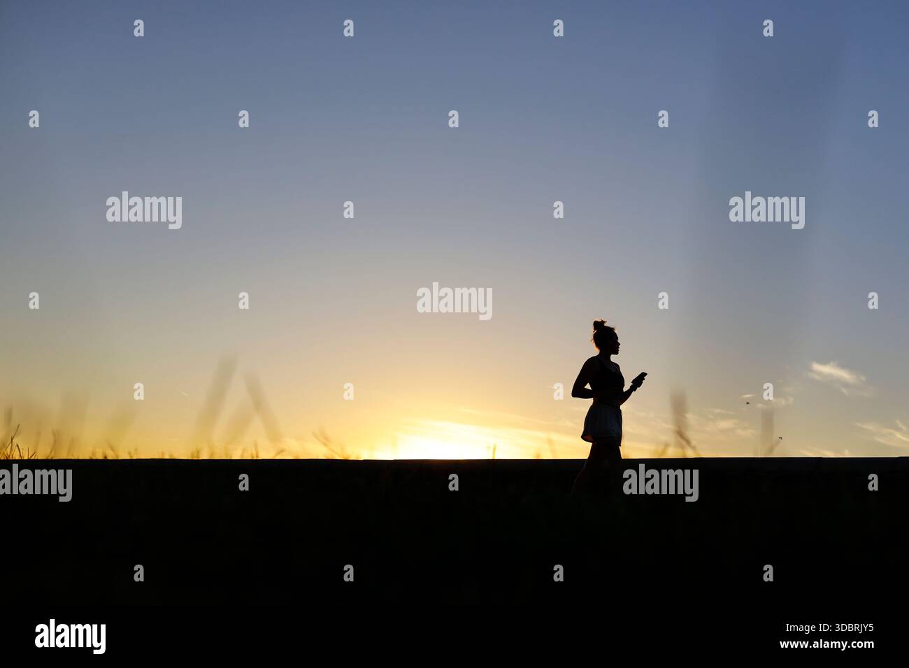 A pedestrian seen walking during sunrise at Altona Beach. The weather ...