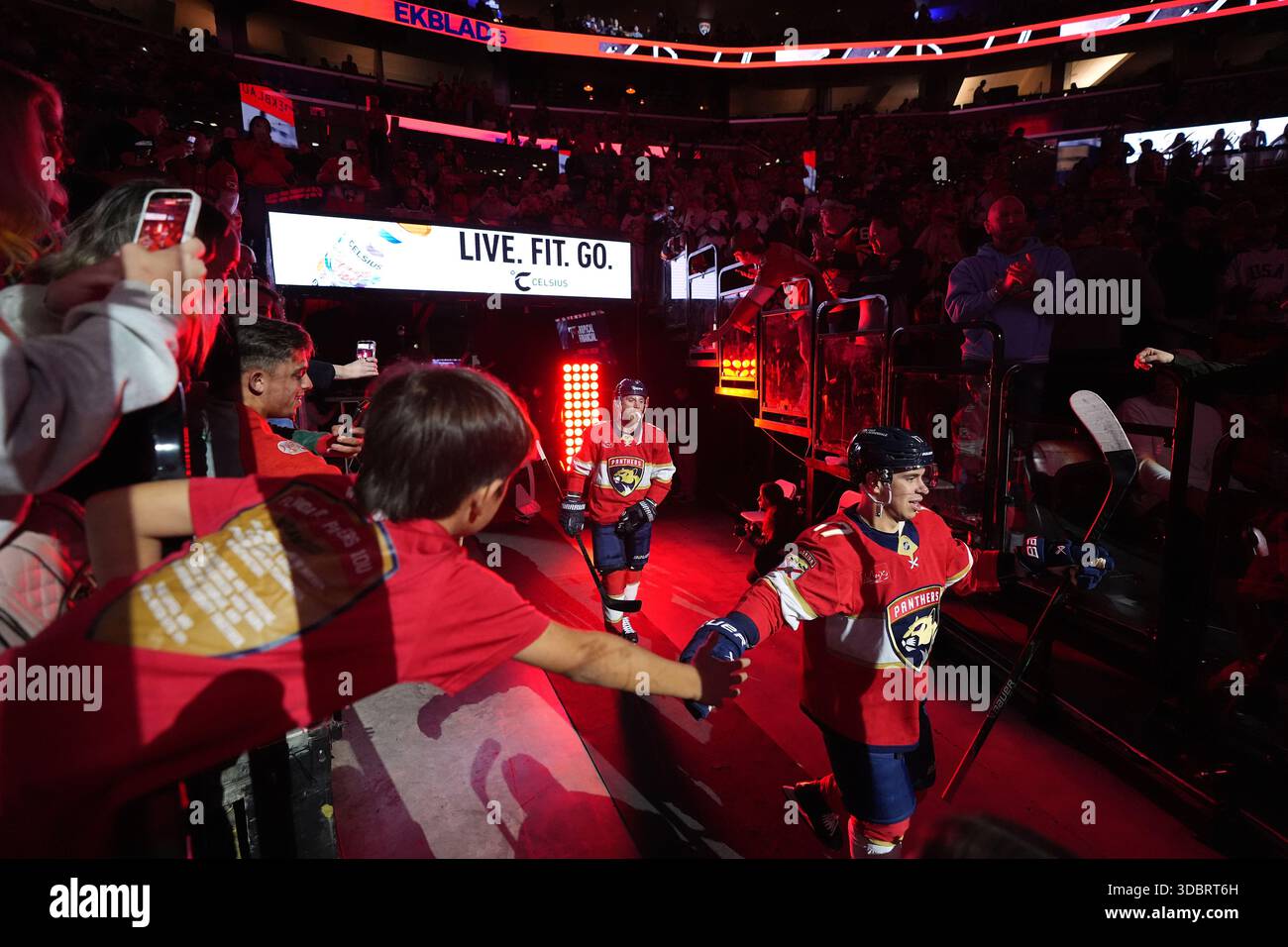 Florida Panthers center Evan Rodrigues (17) claps hands with a young ...