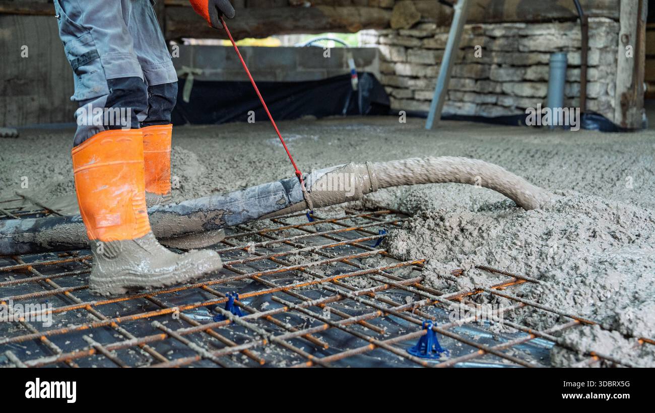 Worker Pours Concrete Slab for Foundation, Ensuring Level Surface and ...