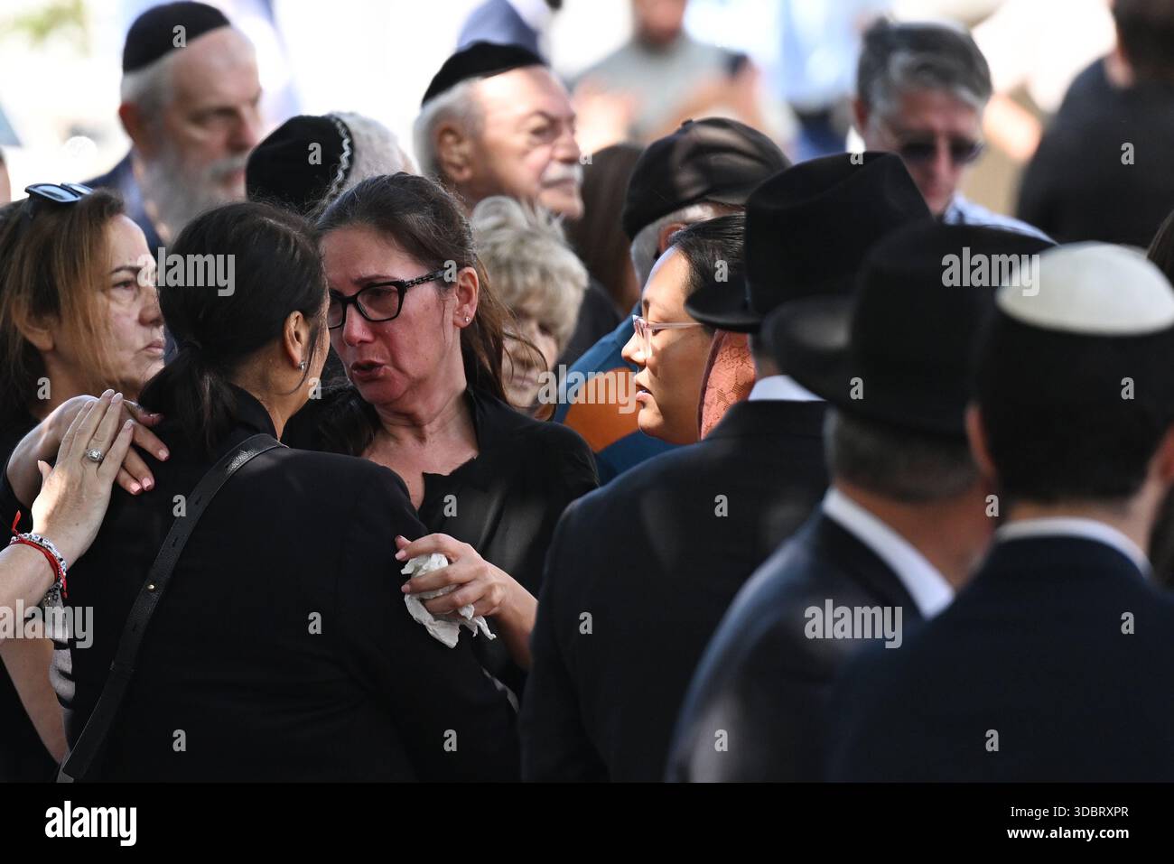 Emotional family and friends mourn as the casket of Tibor Weitzen is ...