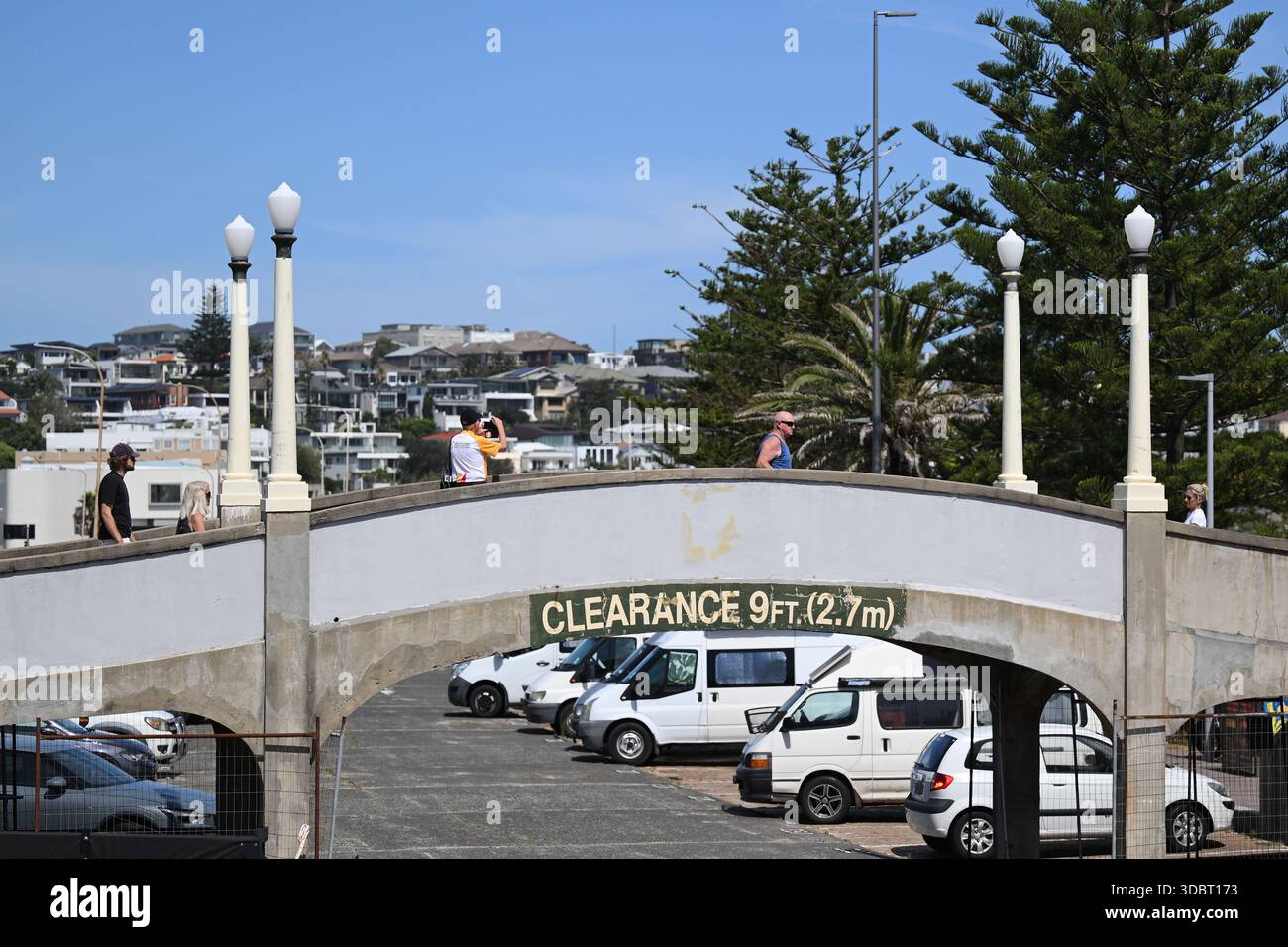 Members of the public cross a walk bridge at the scene of last Sunday's ...