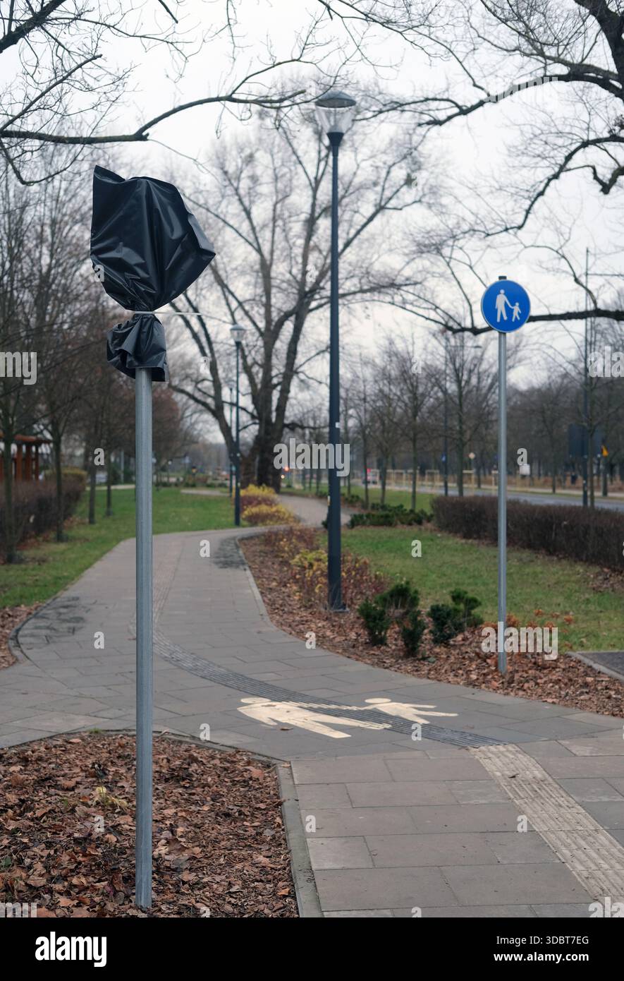 Curved pedestrian and bicycle path with pavement symbols, signpost ...