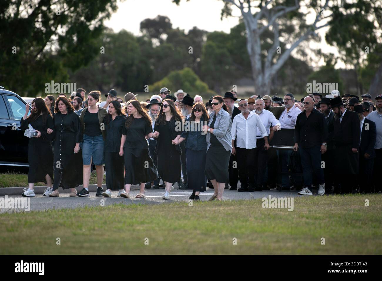 The family of Reuven Morrison walk his coffin to its final resting ...