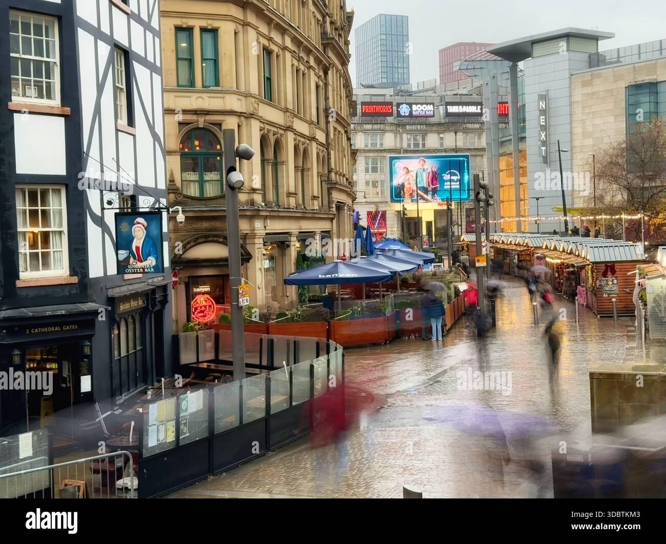 Manchester Christmas Markets in Exchange Square. Blurred figures on a ...