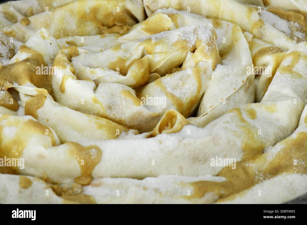 Close-up of an uncooked traditional Cypriot tahini pitta (tahinopita ...