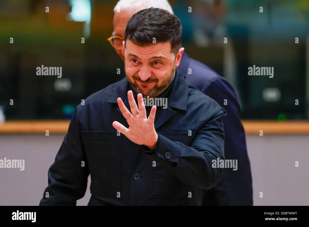 Ukraine's President Volodymyr Zelenskyy waves during a round table meeting at the EU Summit in ...