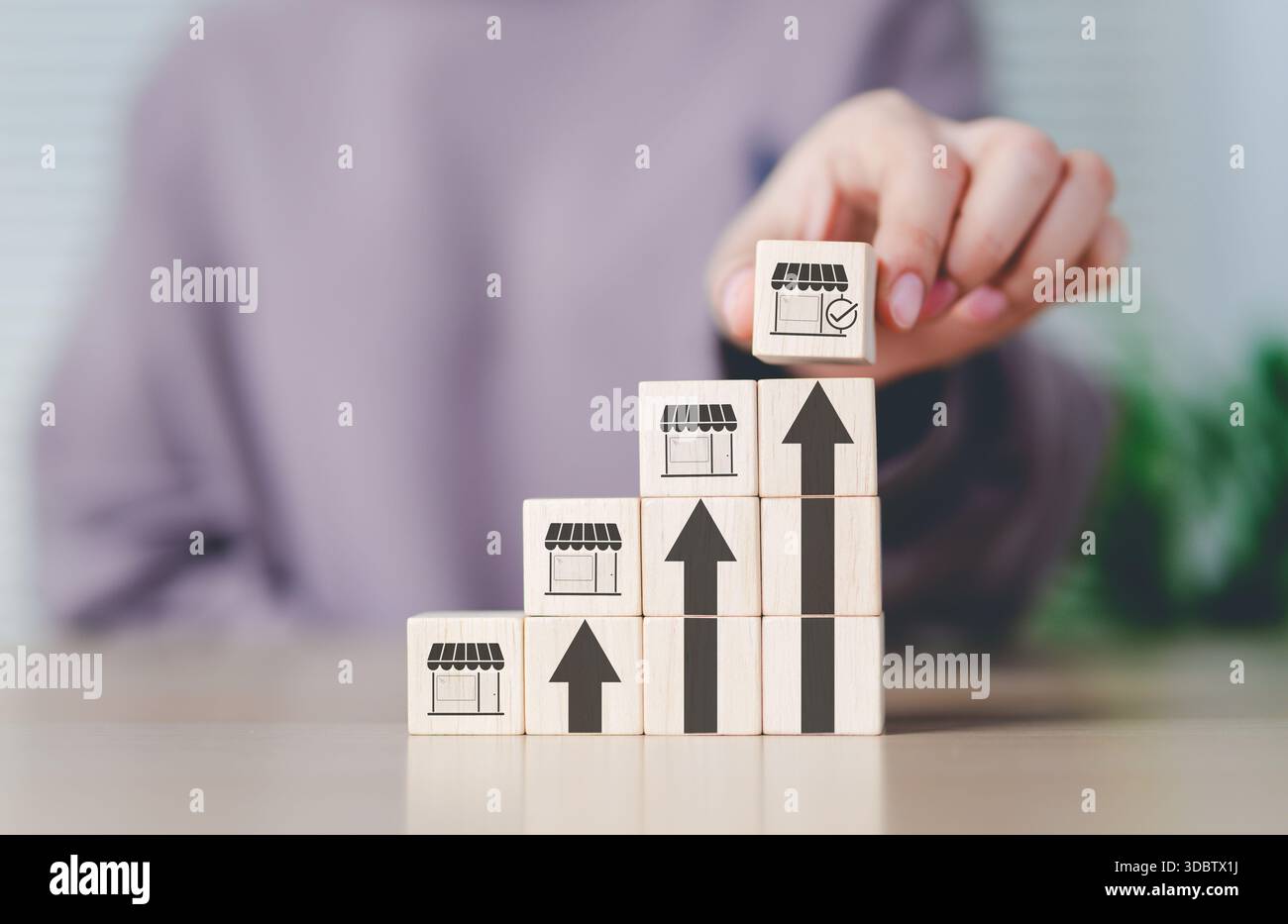 Franchise business growth and expansion concept. Hand stacking wooden ...