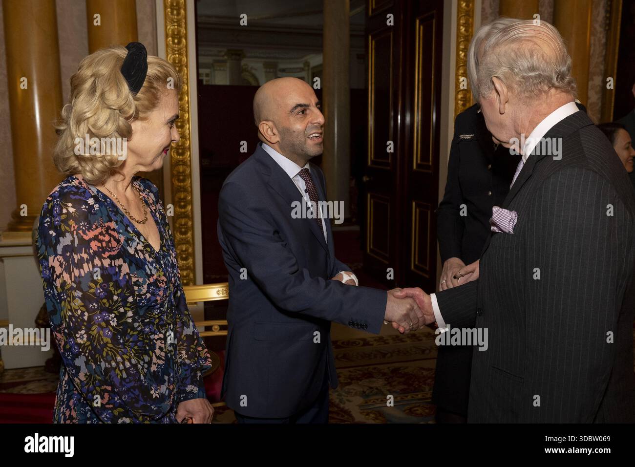 Britain's King Charles III, right, greets Samir Zitouni and his wife ...