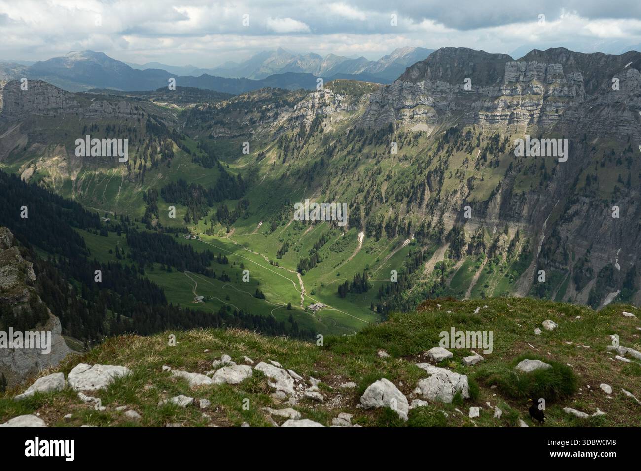 Panoramic view of a green alpine valley and limestone cliffs at ...