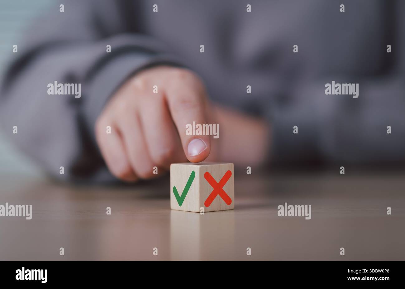 Decision Making and Evaluation Concept. Hand points at wooden cube with ...