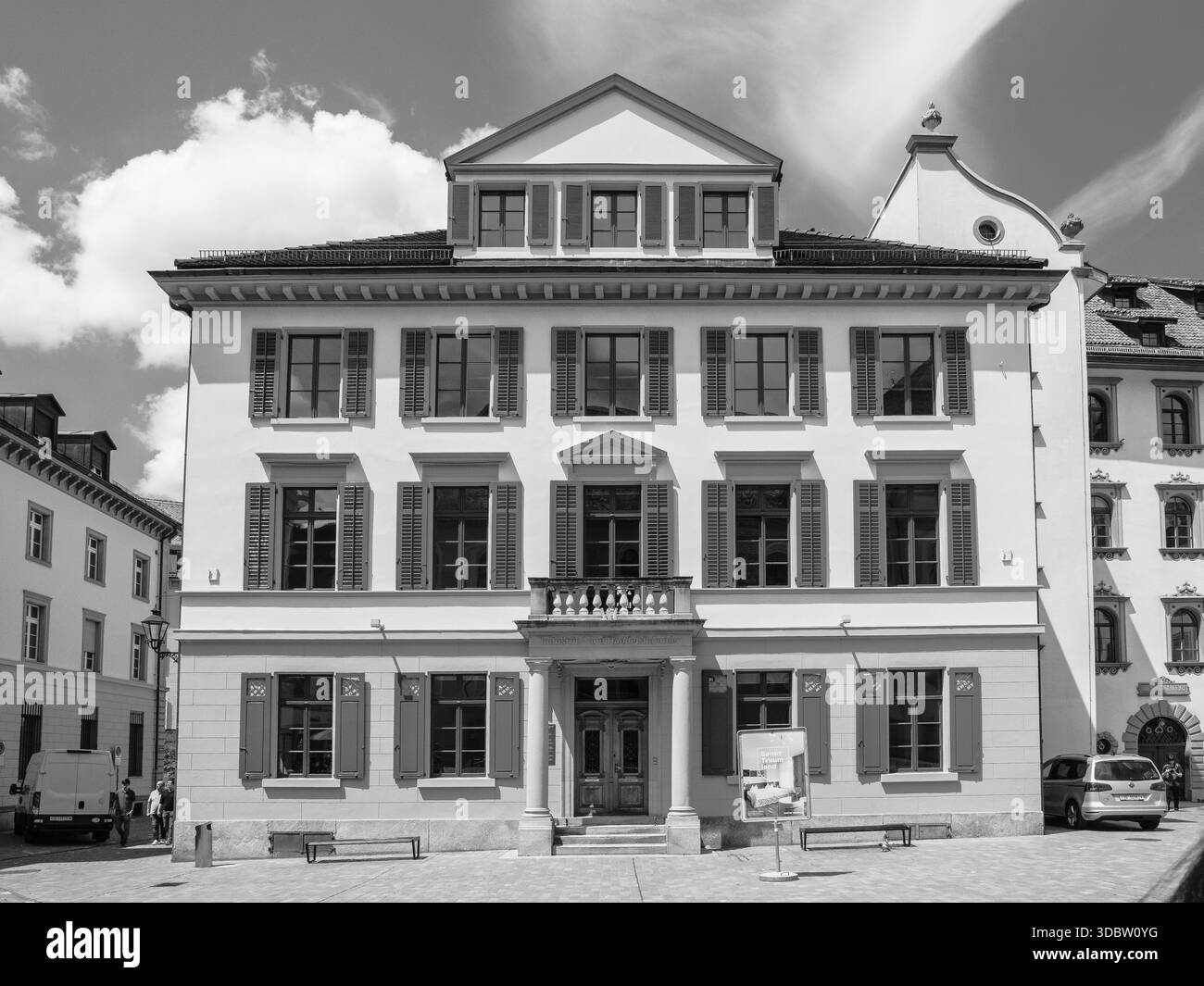 Neoclassical historic building with shuttered windows and stone columns ...