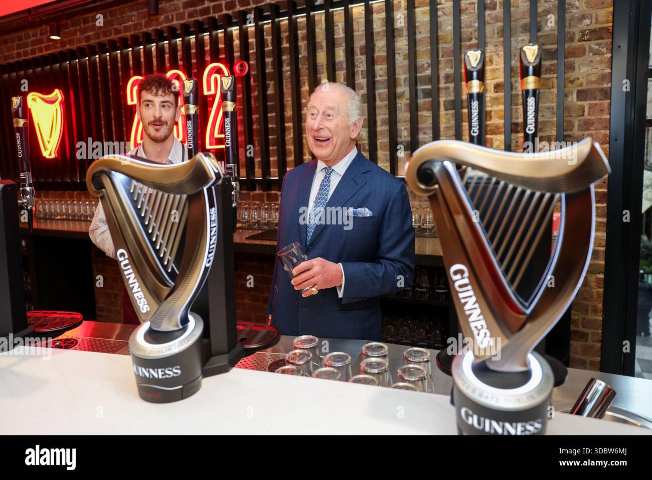 King Charles III pours a pint of Guinness during his visit to the ...