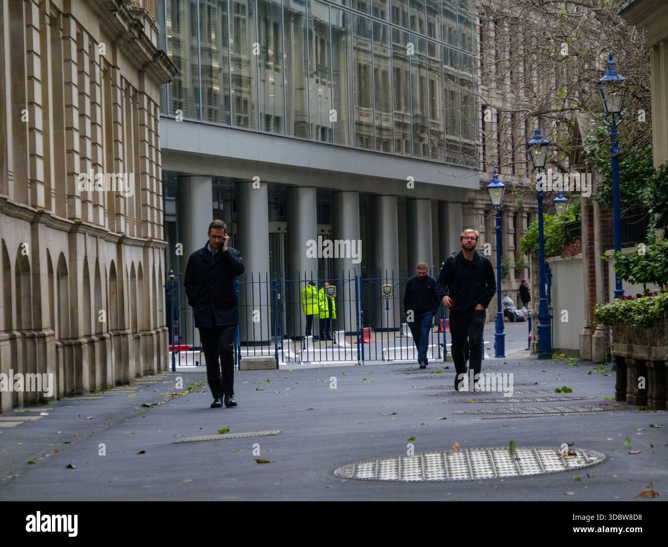 (In centre of picture) security guards wearing yellow fluorescent coats ...