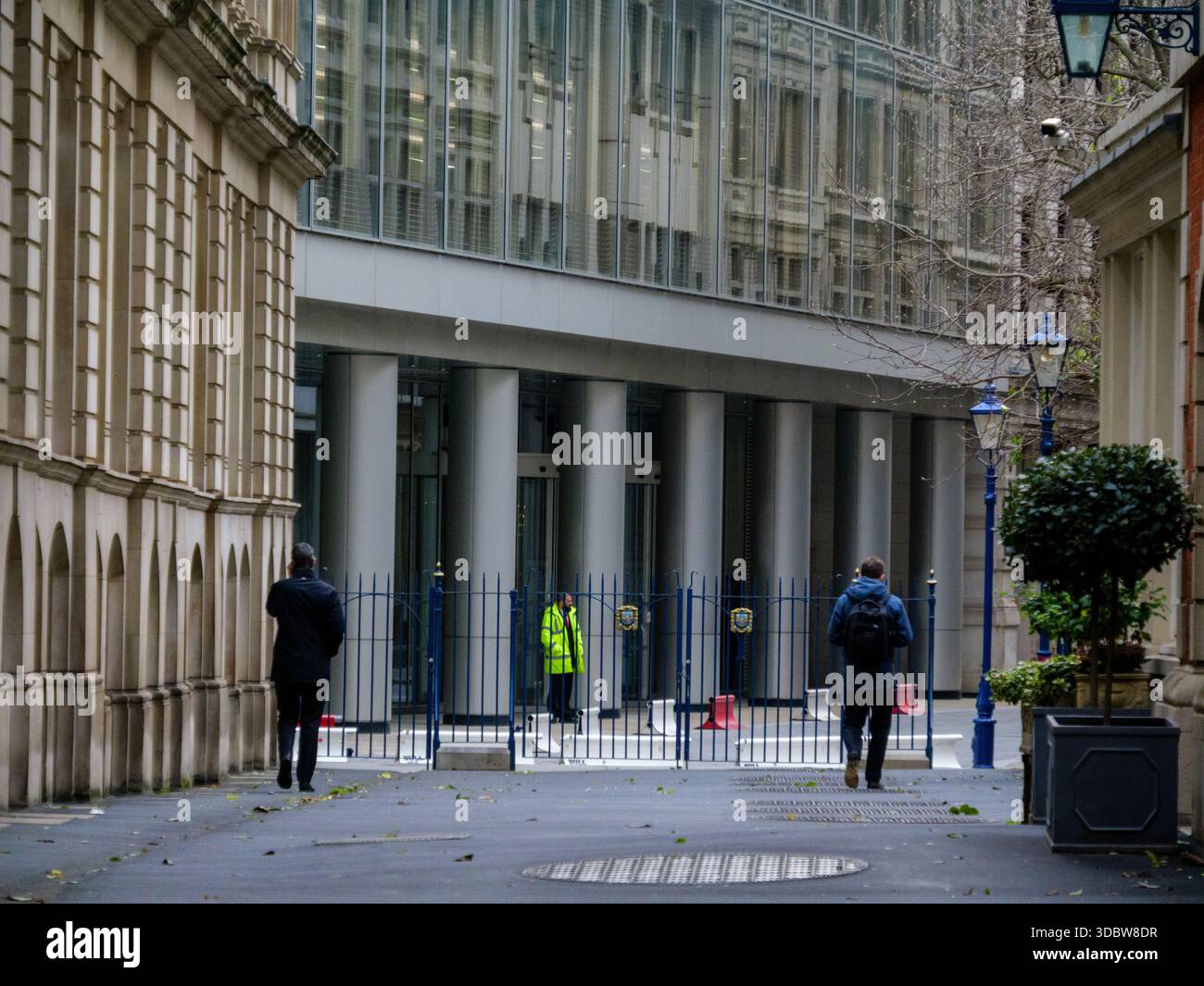(In centre of picture) security guards wearing yellow fluorescent coats ...