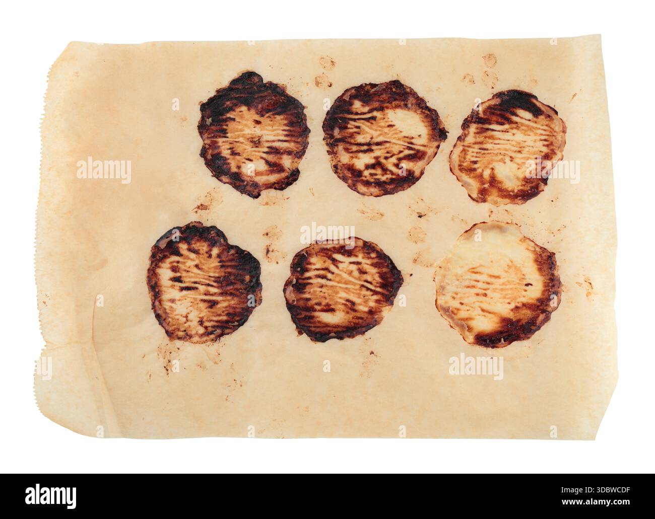 Kitchen parchment sheet with baked meat patty stains, isolated on a ...
