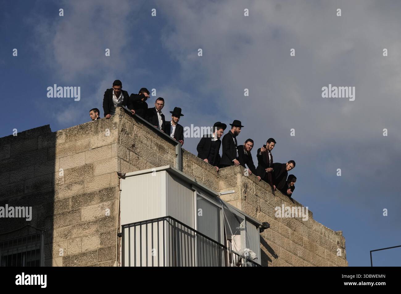 Ultra-Orthodox Jewish men on a rooftop watch during a violent ...