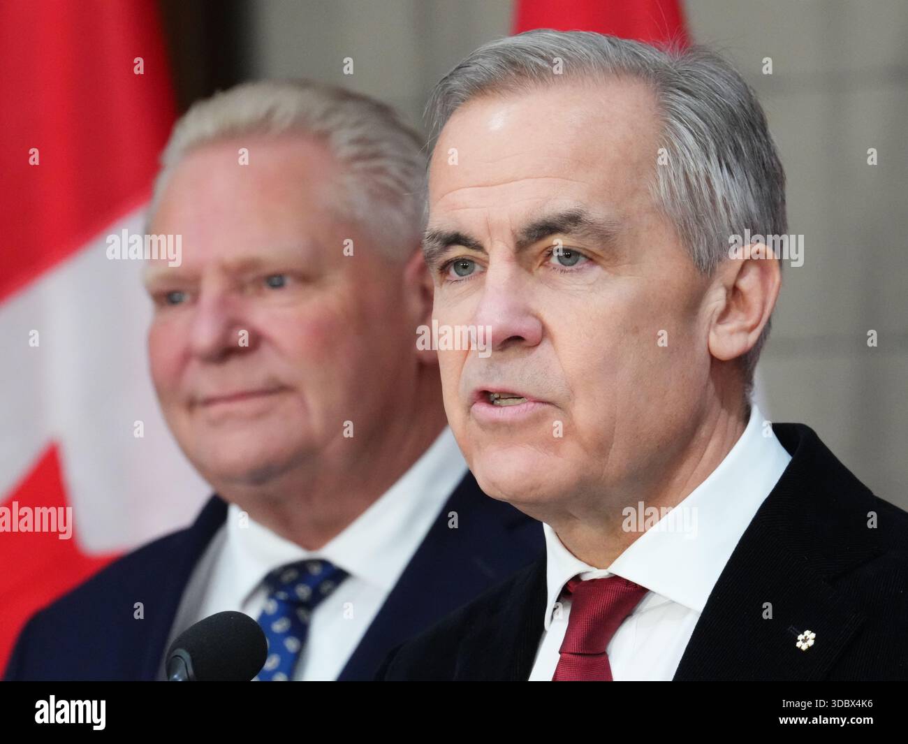 Prime Minister Mark Carney, right, and Ontario Premier Doug Ford hold a ...