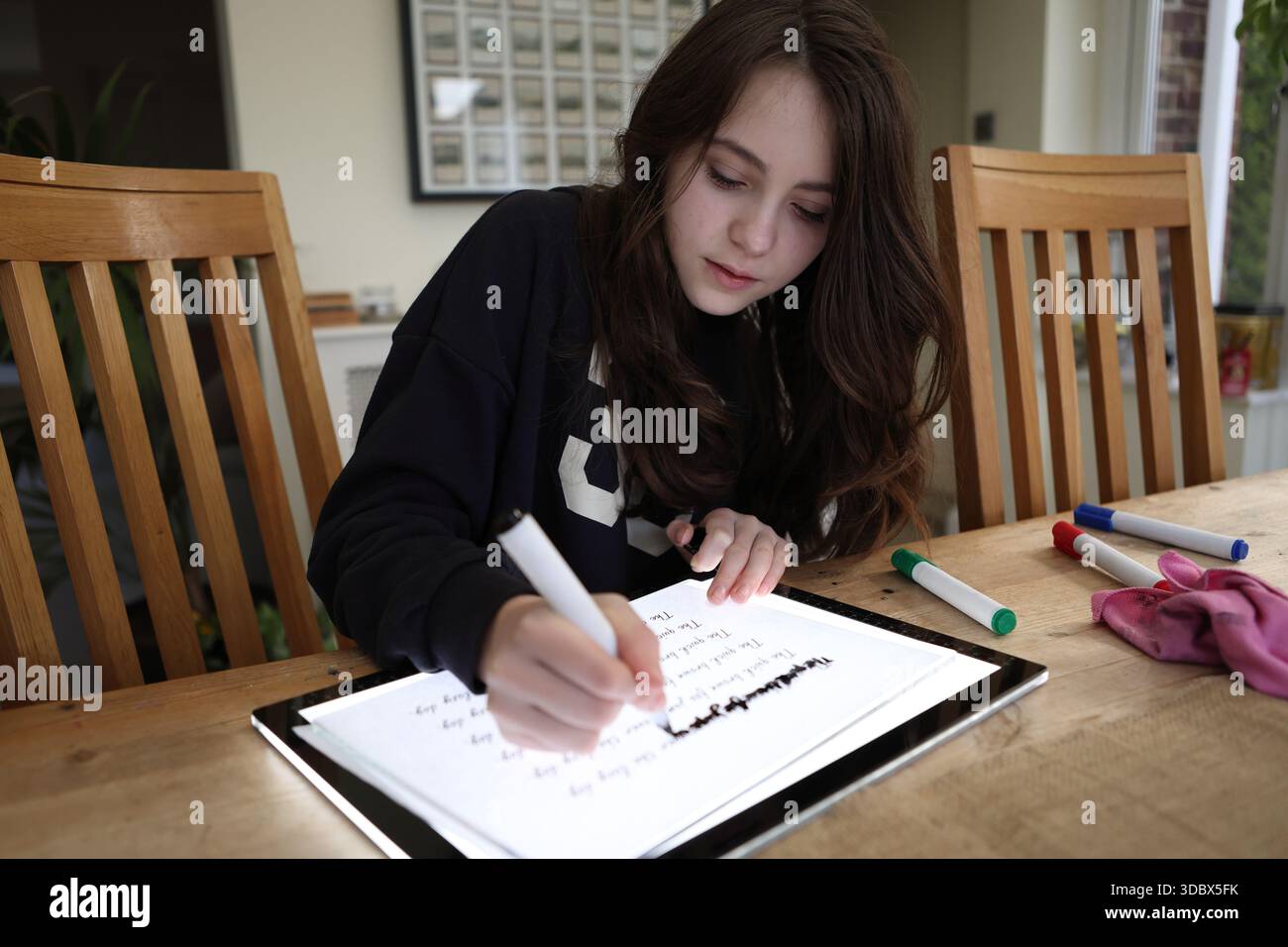 Girl writing practising handwriting lettering on whiteboard Stock Photo ...