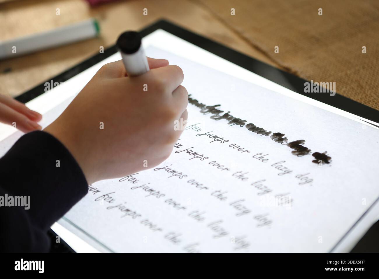 Girl writing practising handwriting lettering on whiteboard Stock Photo ...