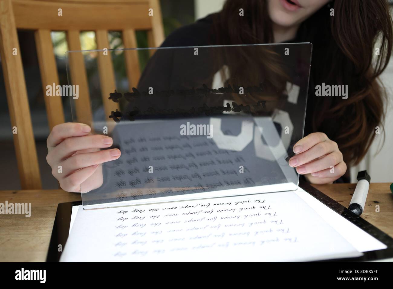 Girl writing practising handwriting lettering on whiteboard Stock Photo ...