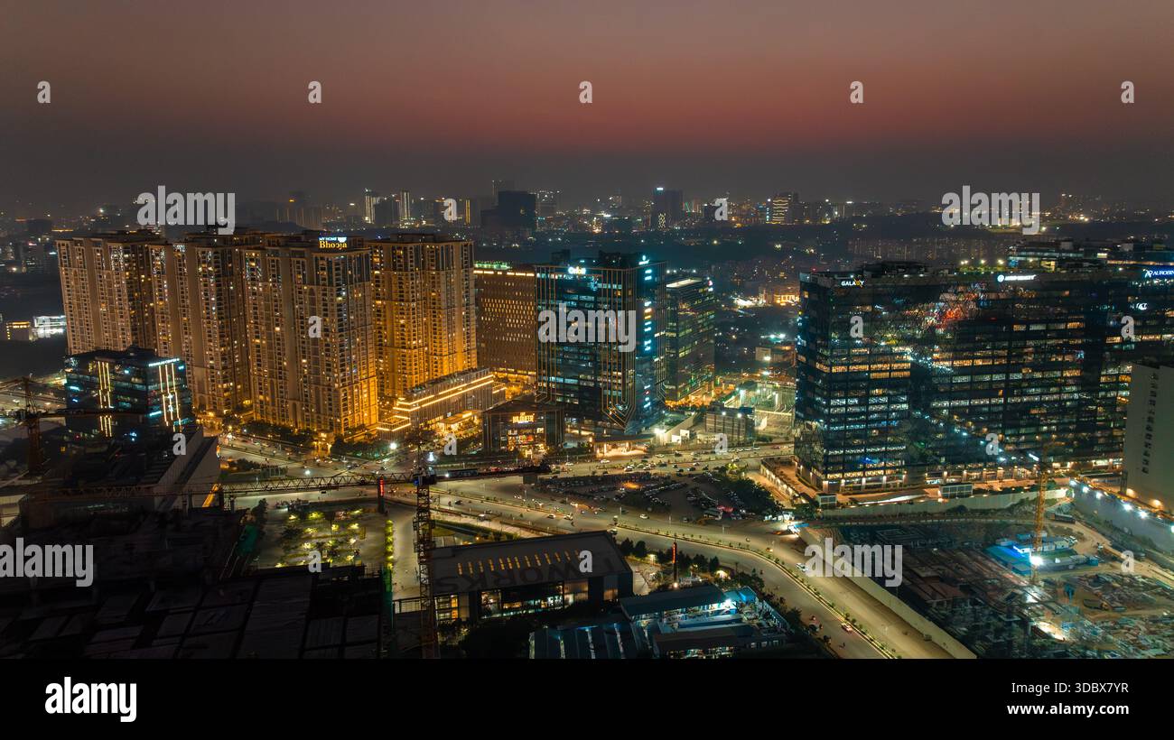 Aerial view of gleaming skyscrapers reflecting the vibrant city lights ...