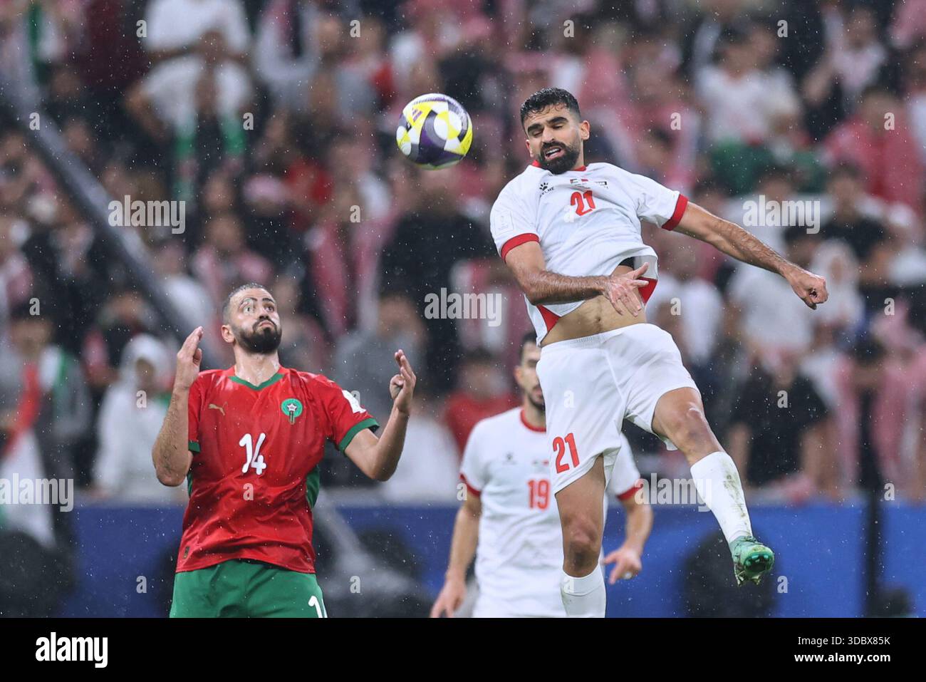 Jordan's Nizar Al Rashdan, top, heads the ball next to Morocco's ...
