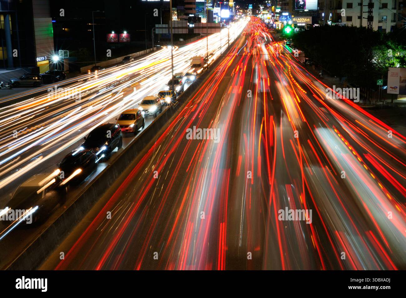 In this photo taken with a slow shutter speed, light trails from heavy ...