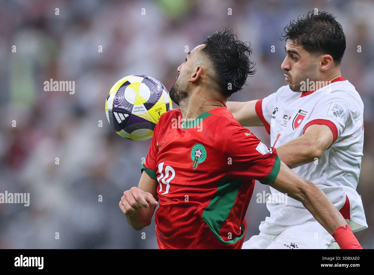 Morocco's El Moussaoui Hamza, left, goes for a header with Jordan's Mohammad Abu Zraiq during to ...