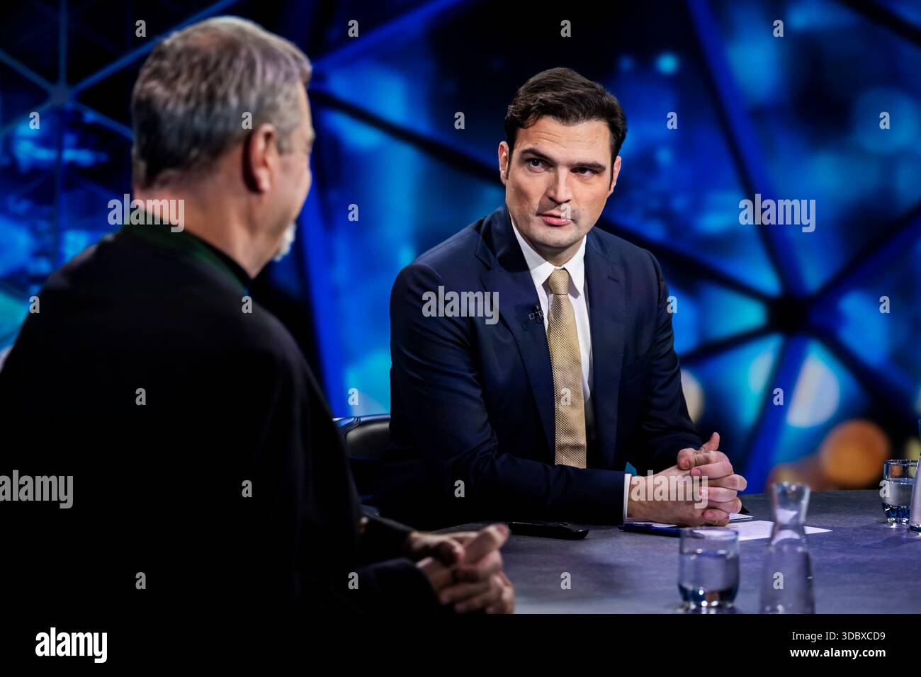 18 December 2025, Berlin: Jan Philipp Burgard (r), TV journalist, and ...