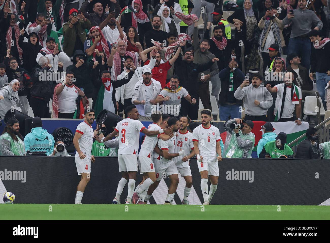 Jordan's Ali Olwan, center, celebrates with teammates after scoring ...