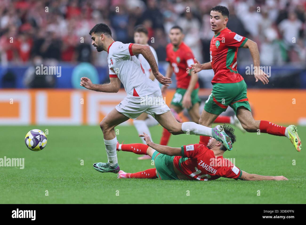 Jordan's Nizar Al Rashdan, left, vies for the ball with Morocco's Amin ...