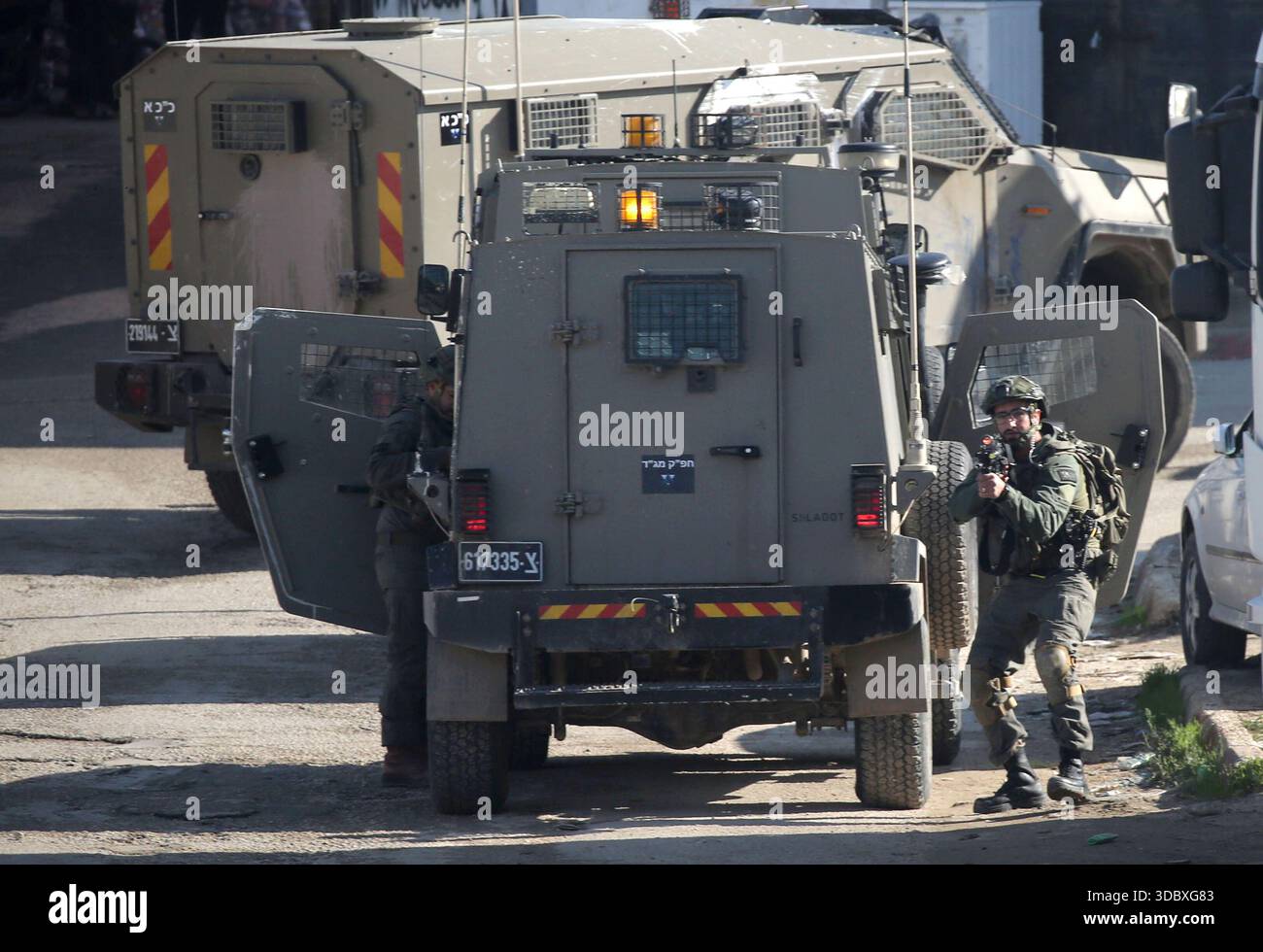 An Israeli soldier aims his weapon during a raid on the Askar refugee ...