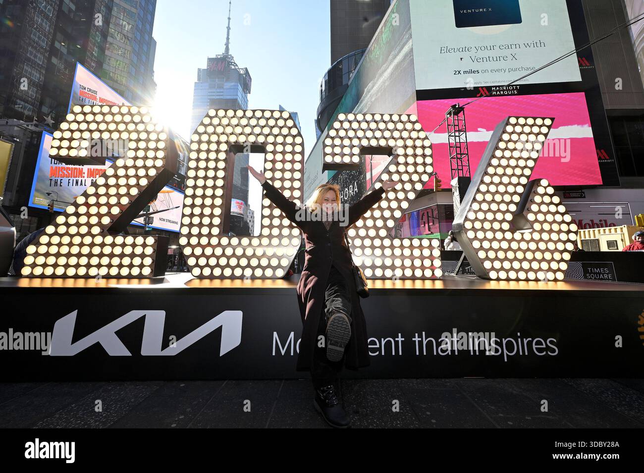 People pose in front of the '2026' New Year's Eve ball drop numerals ...