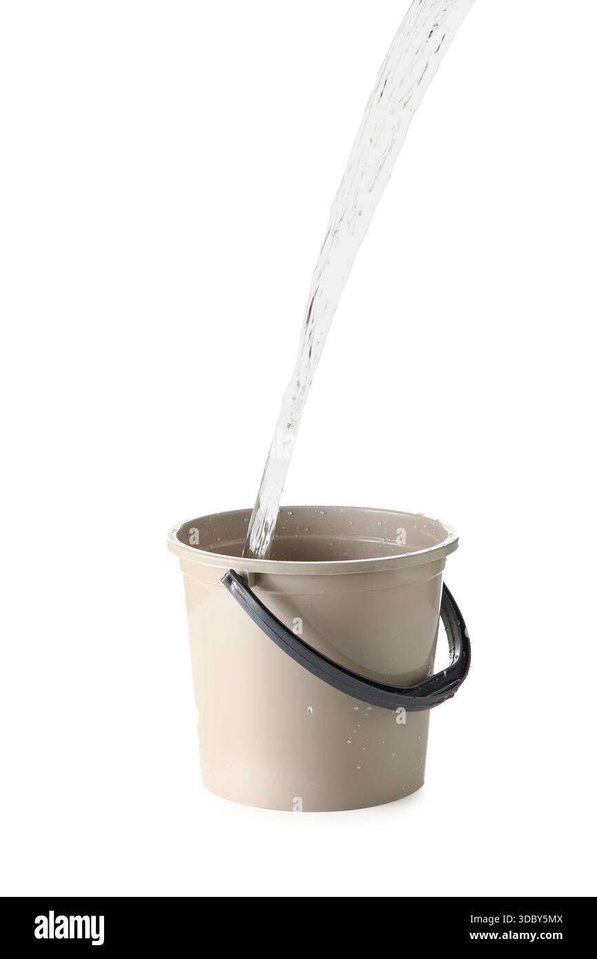 Pouring of water into grey bucket on white background Stock Photo - Alamy