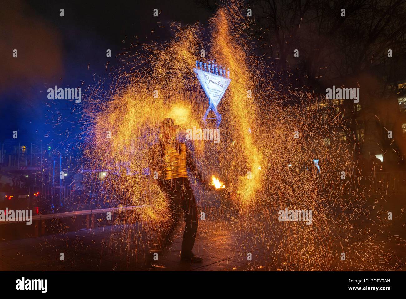 An artist performs with fire during the Jewish holiday of Hanukkah at ...