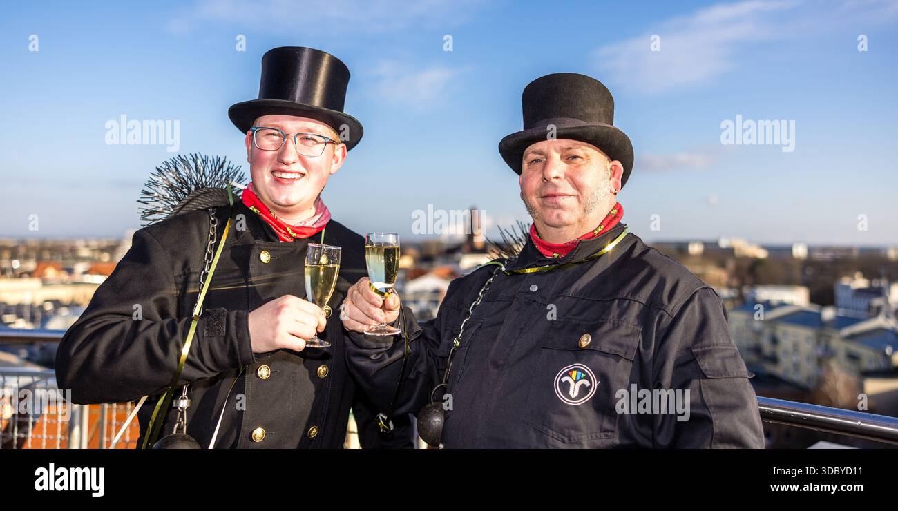 11 December 2025, Brandenburg, Cottbus: Chimney sweeps Niklas Schuppan ...