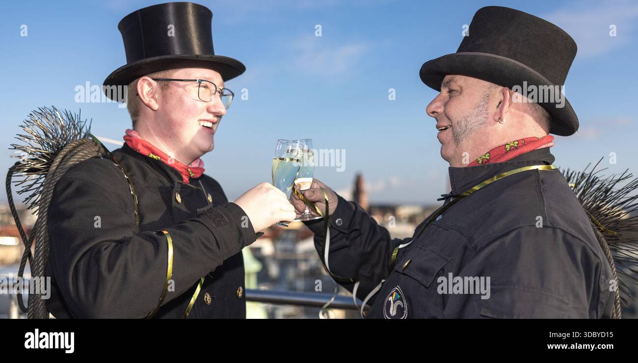 11 December 2025, Brandenburg, Cottbus: Chimney sweeps Niklas Schuppan ...
