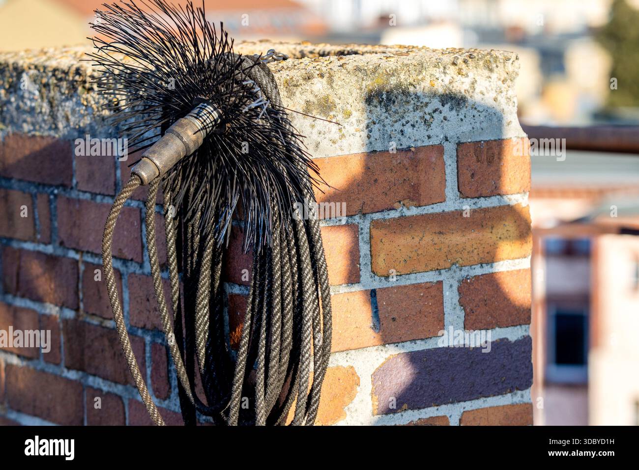 17 December 2025, Brandenburg, Cottbus: A chimney sweep's sweeper hangs ...