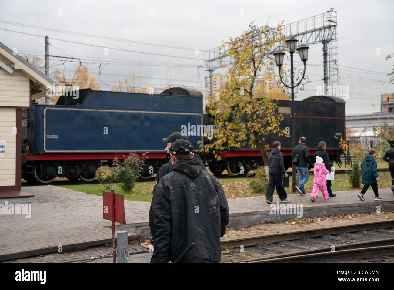 Moscow, Russia - October 18, 2025: railway workers walk along a path ...