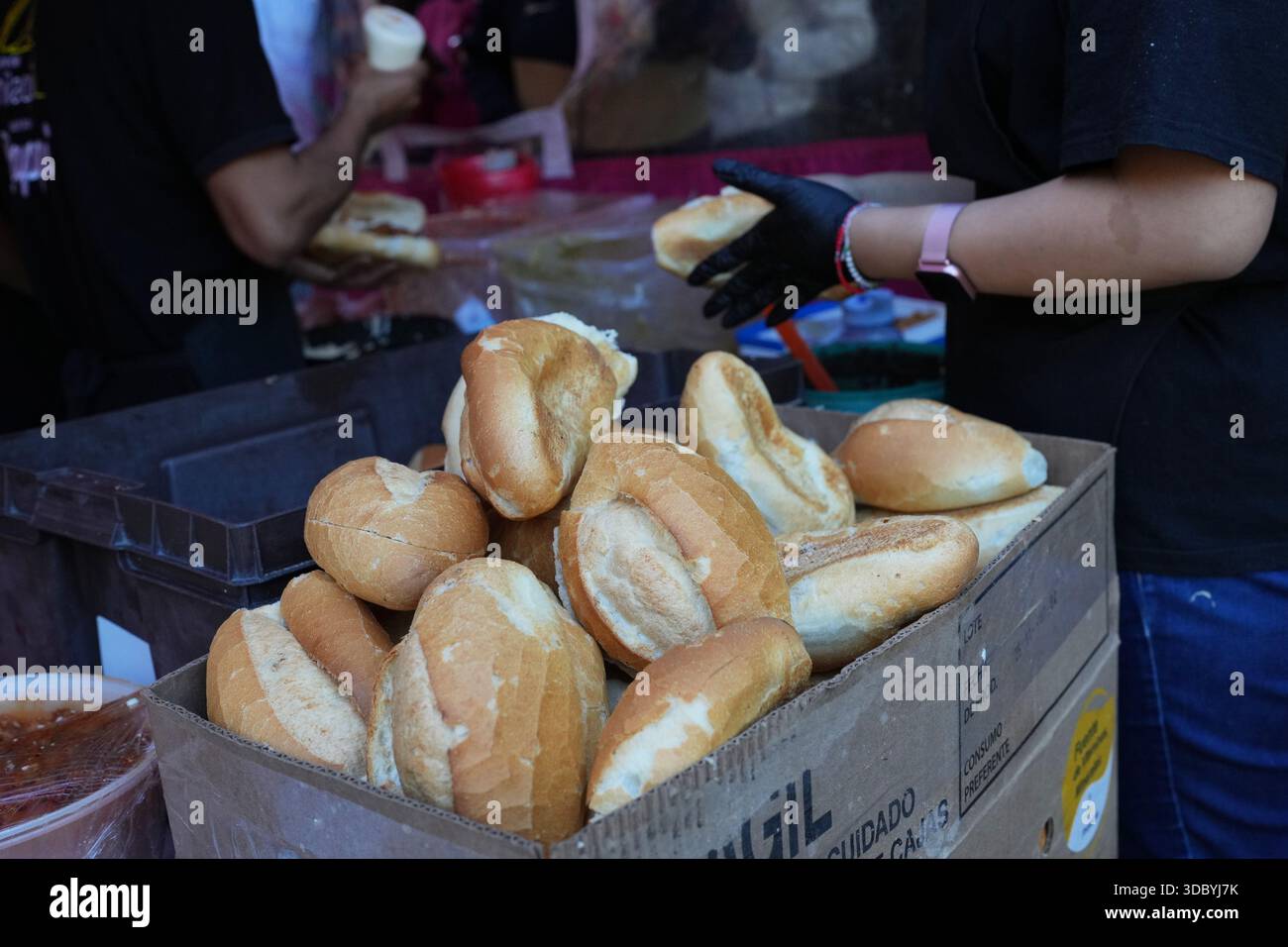 Bolillos, a traditional Mexican bread, sit for sale at a street stand ...