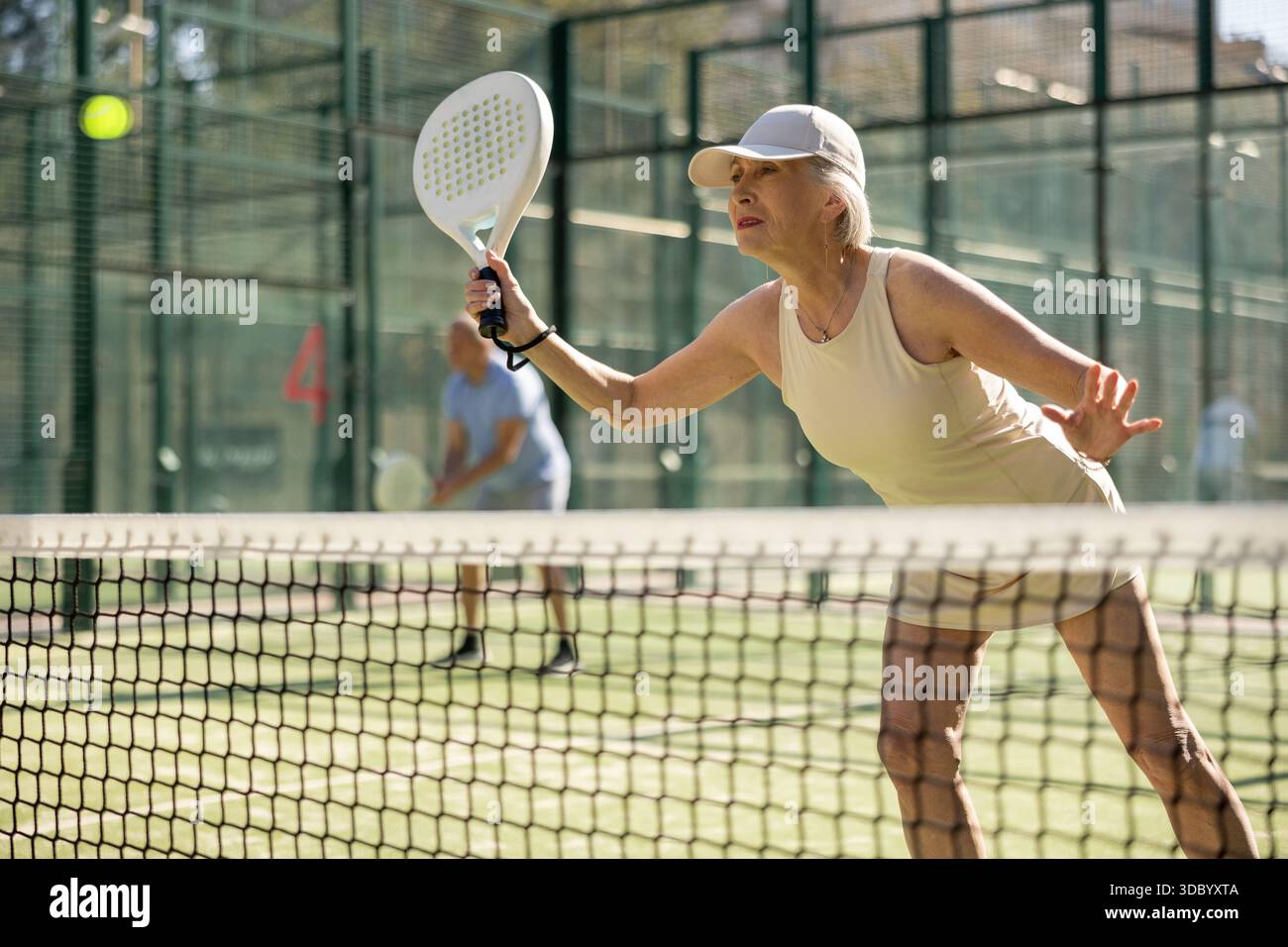 Old woman playing Padel Tennis in open-air tennis court Stock Photo - Alamy