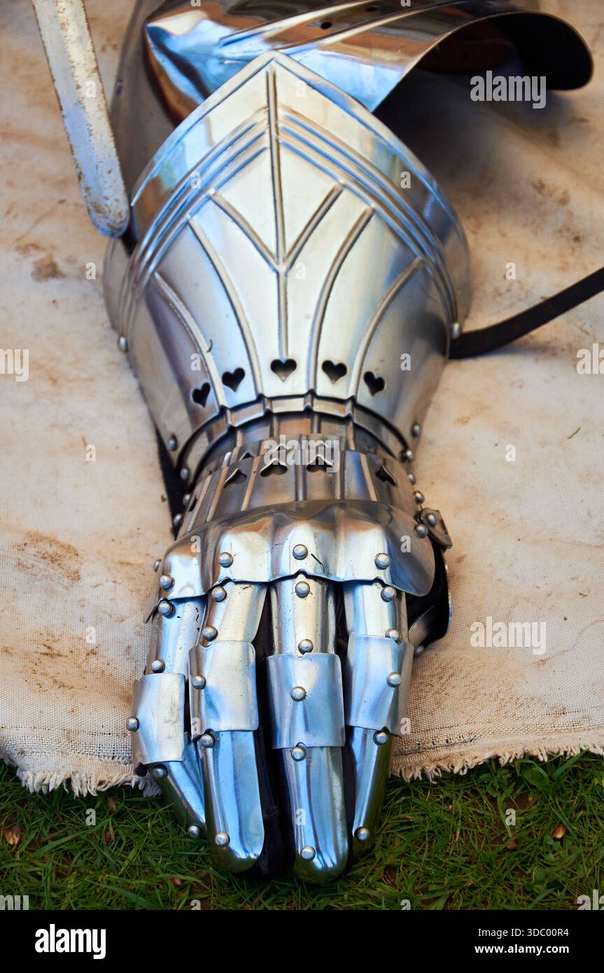 A steel medieval armor gauntlet displayed on the ground, showcasing ...