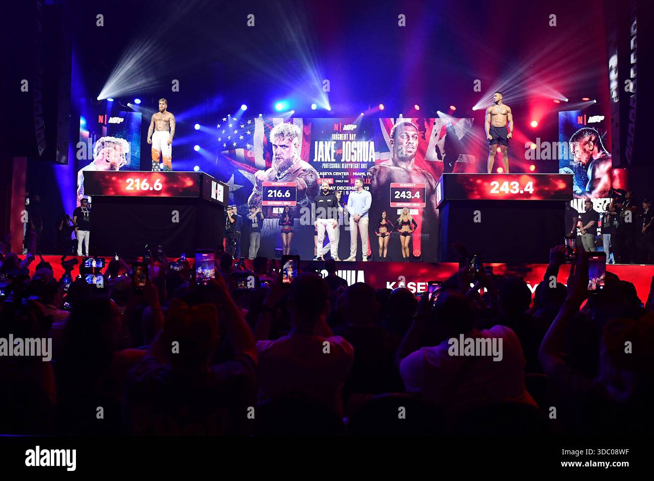 Jake Paul and Anthony Joshua stand on an elevated platform during the ...