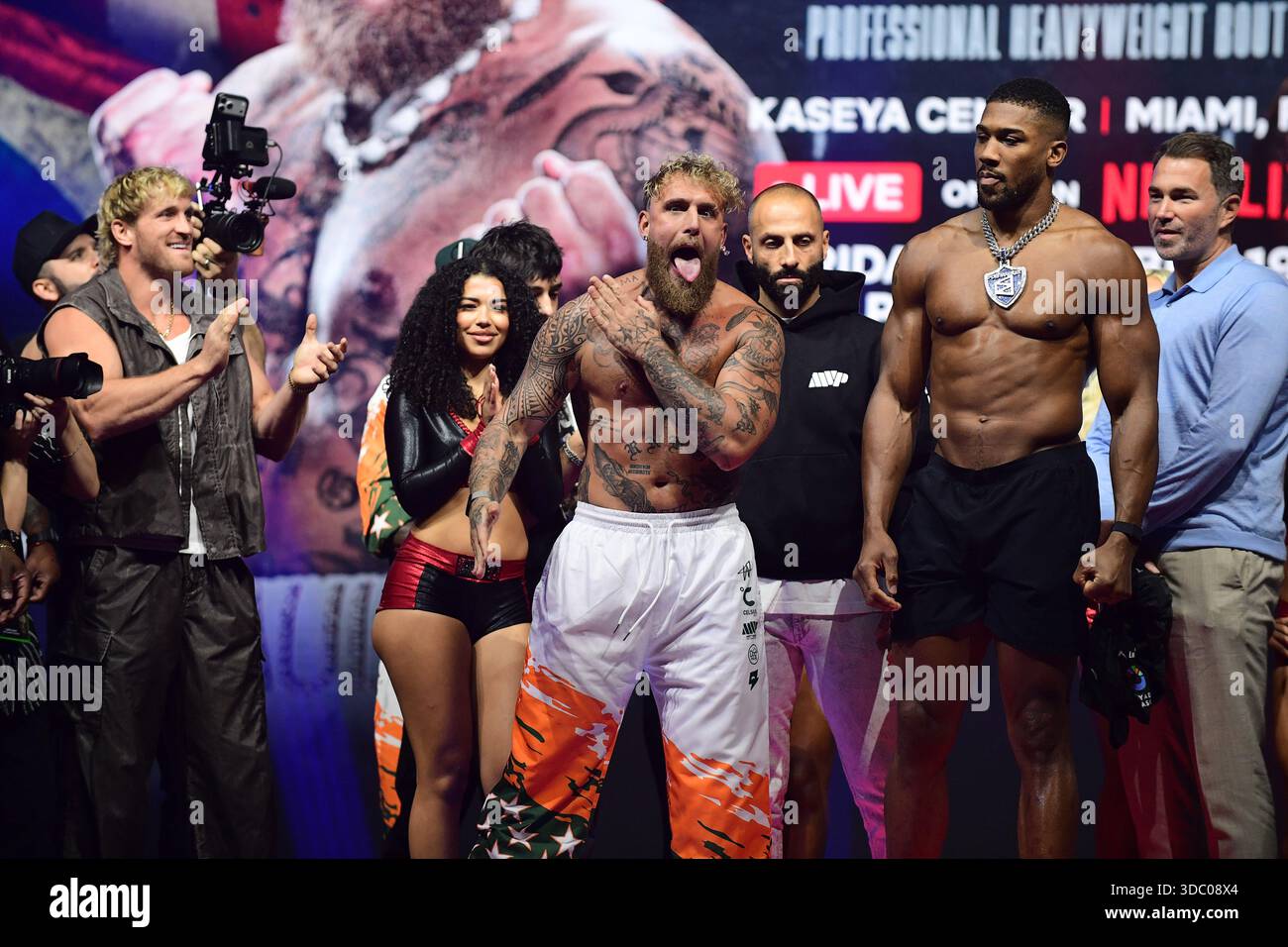 Jake Paul poses for the cameras as Anthony Joshua looks on during the ...