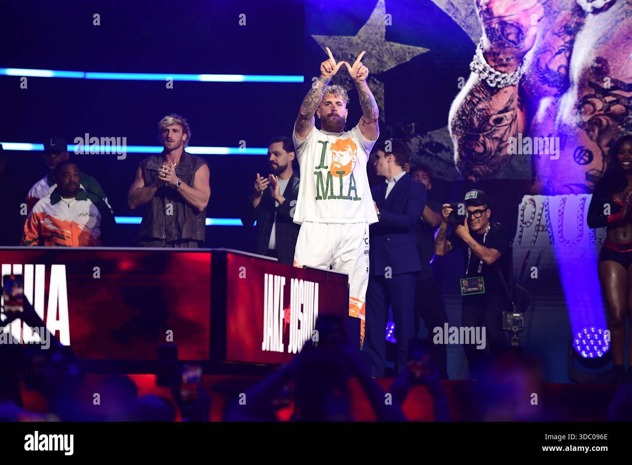 Jake Paul makes a hand gesture as he walks on the stage during the ...