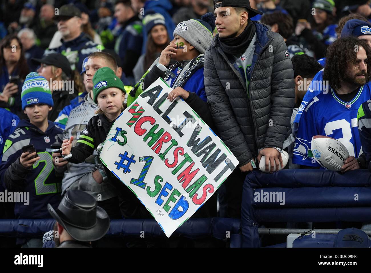 Fans watch as players warm up before an NFL football game between the ...
