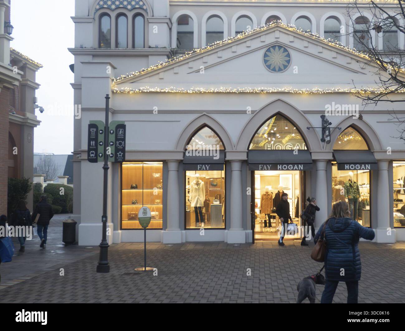 Fashion store exterior with glowing lights and display windows in ...