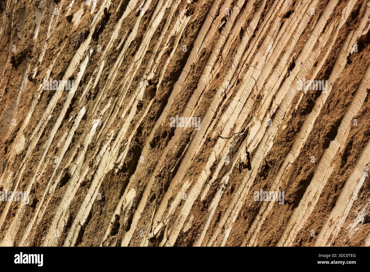 Brown soil texture background showing diagonal grooves with rough ...
