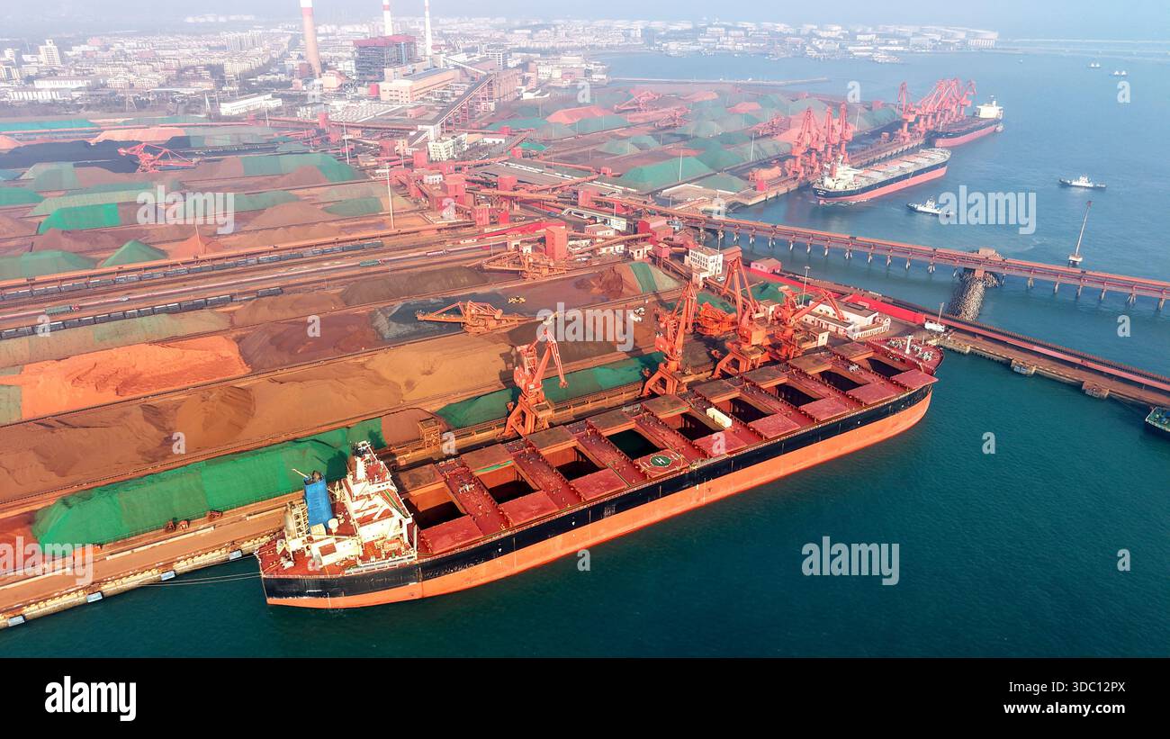 QINGDAO, CHINA - DECEMBER 19, 2025 - A cargo ship unloads imported iron ...