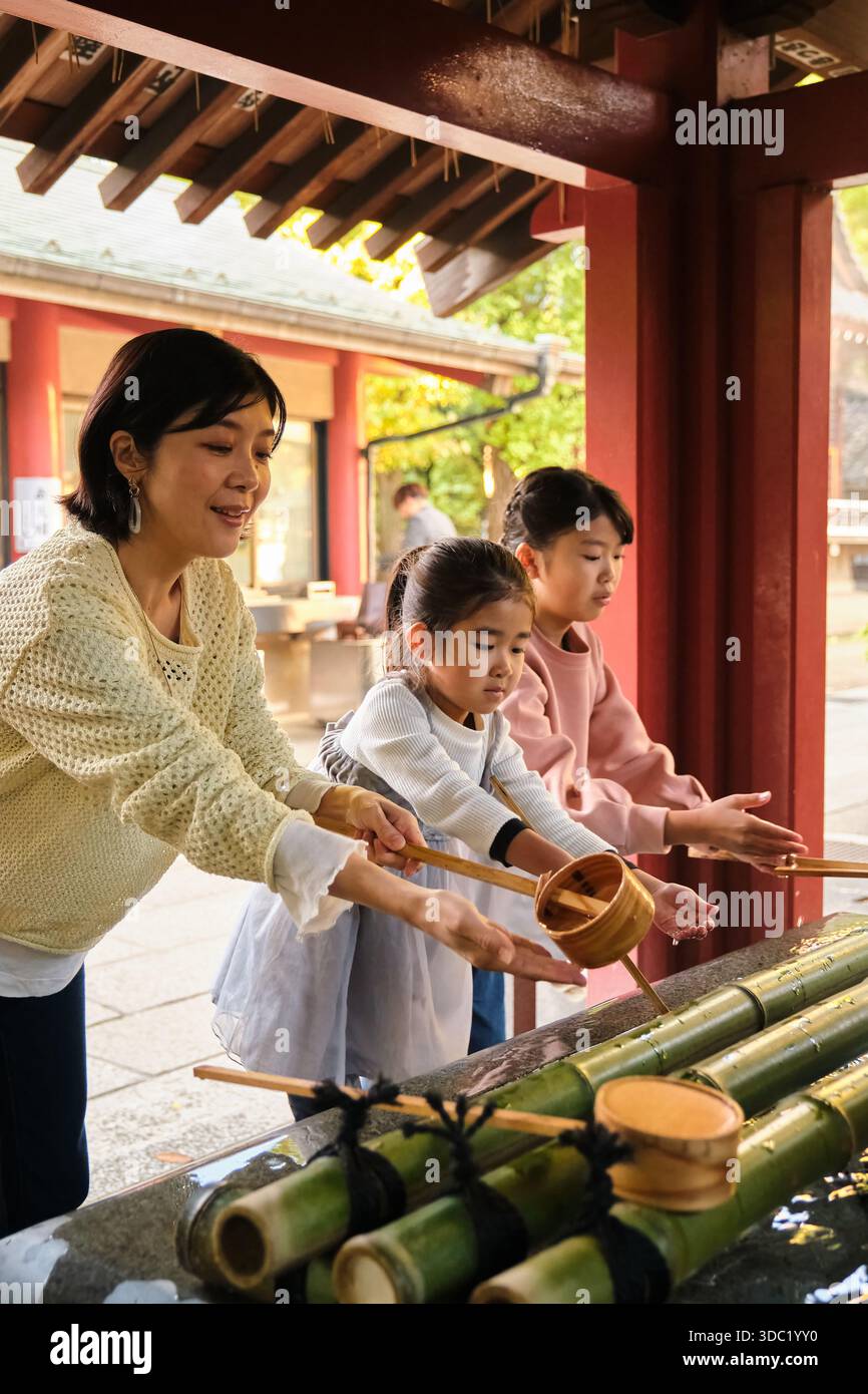 Japanese family performing purification ritual at Chozuya Stock Photo ...